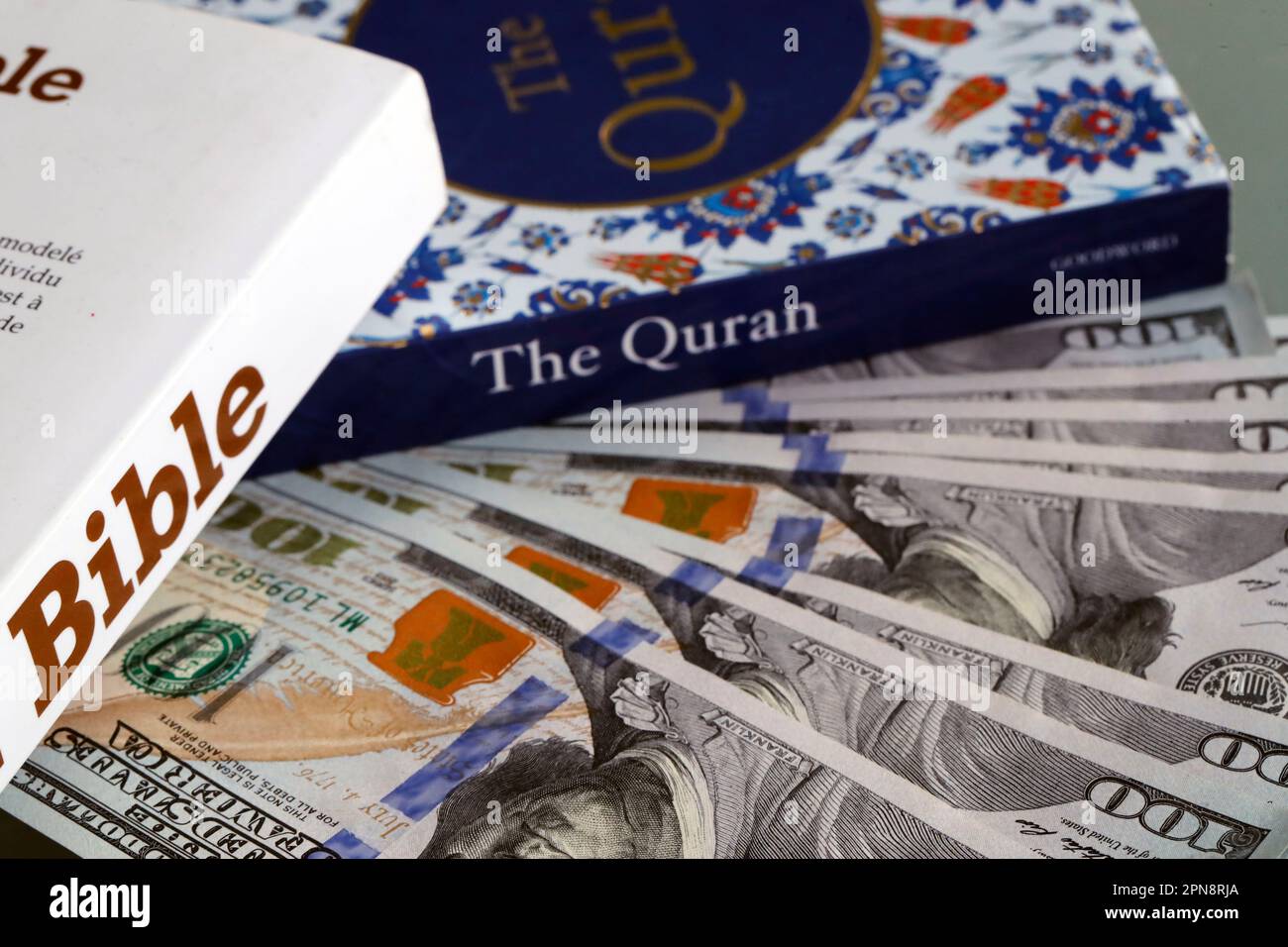 Money, religion and interfaith. Banknotes of US dollars with Bible and ...