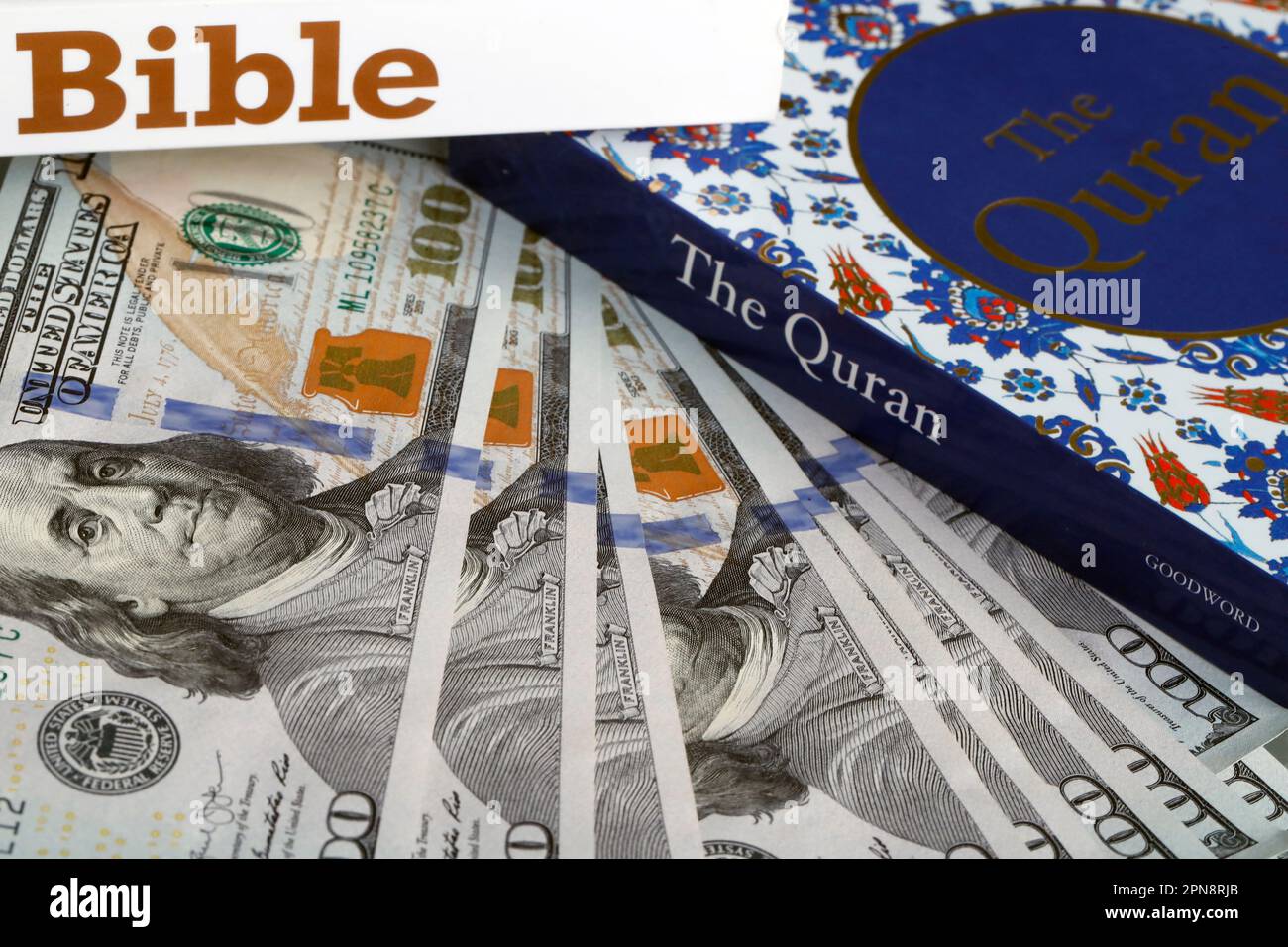 Money, religion and interfaith. Banknotes of US dollars with Bible and ...