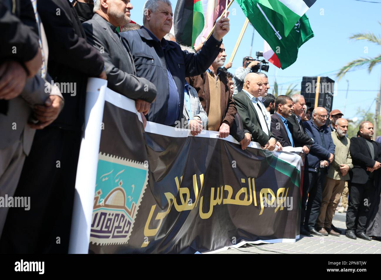 Palestinians wave flags during a protest held to mark Al-Quds ...