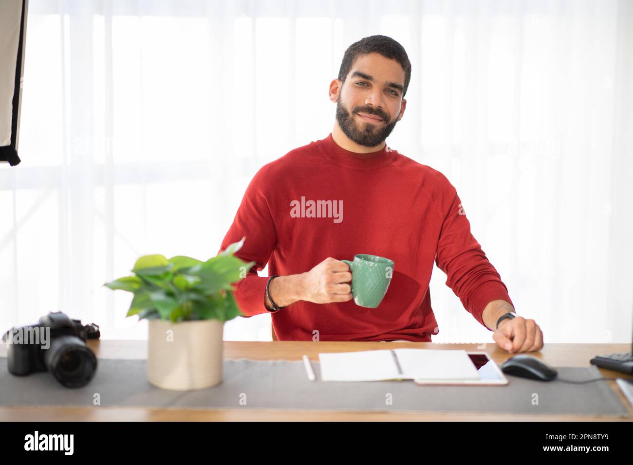 Portrait Of Cheerful Handsome Man Photographer Posing At Workplace