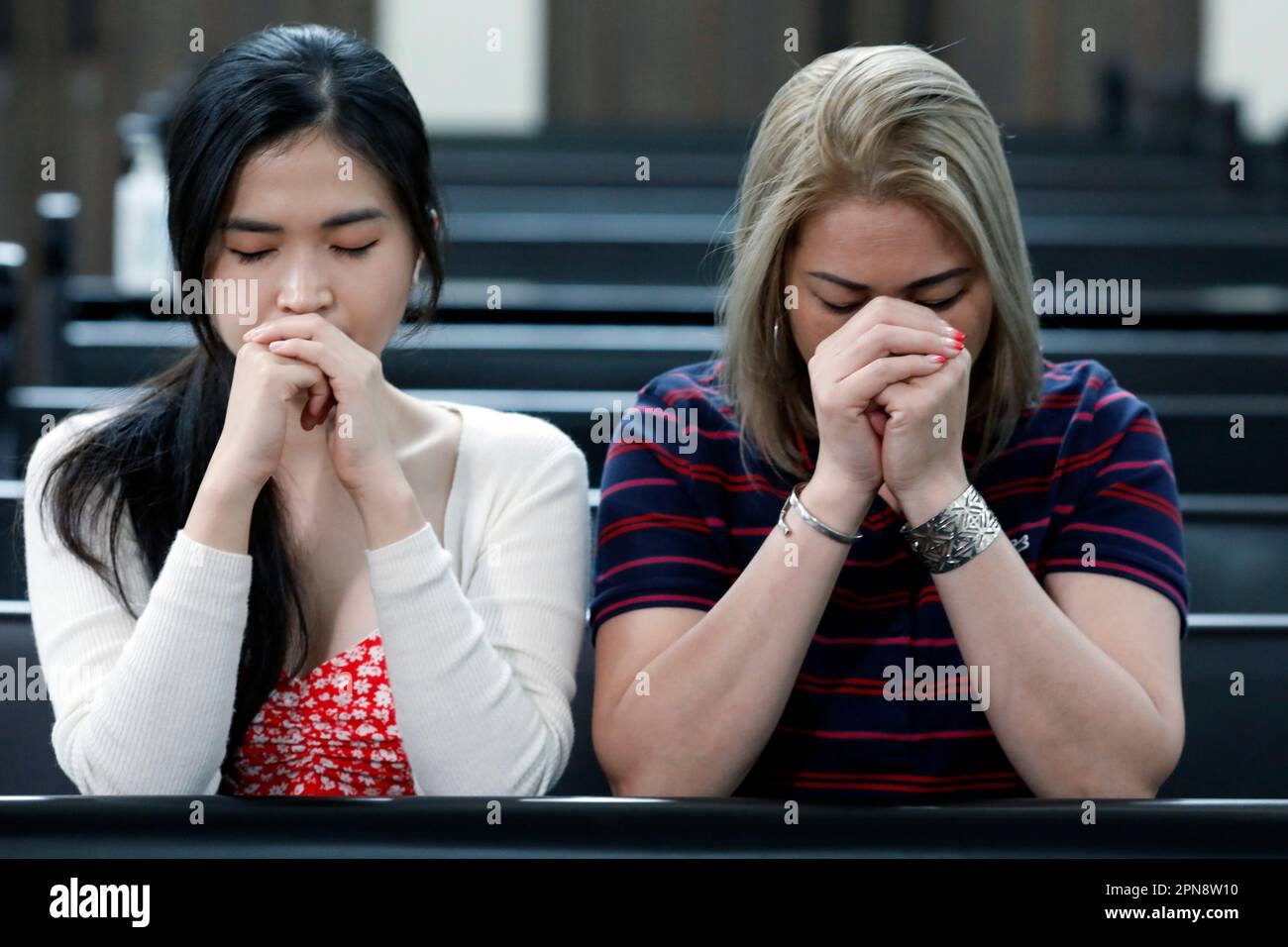 St Joseph's church. Asian women praying together. Singapore Stock Photo ...