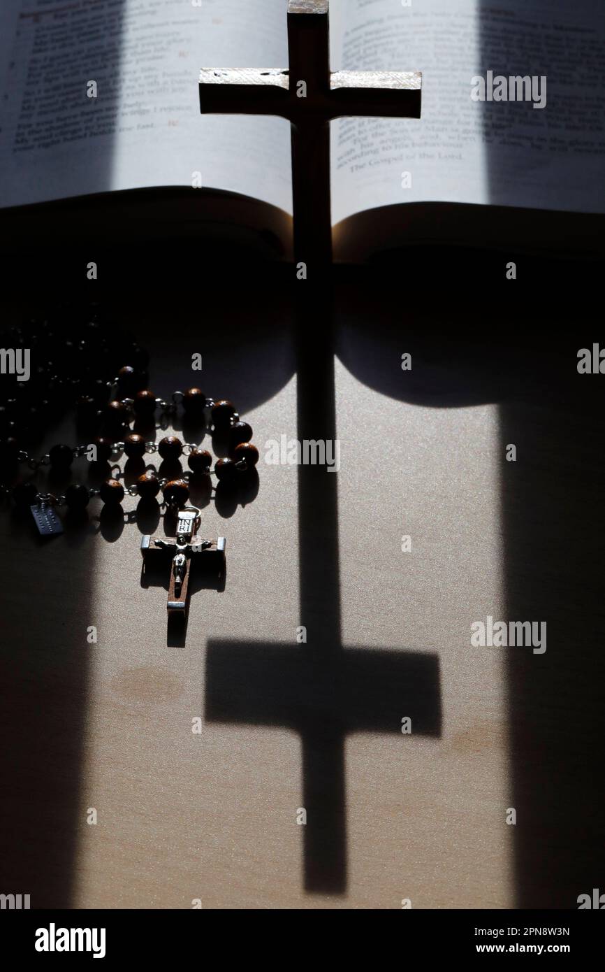 Open bible shadow cross hi-res stock photography and images - Alamy