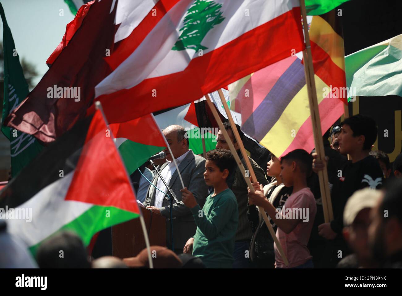 Palestinians wave flags during a protest held to mark Al-Quds ...