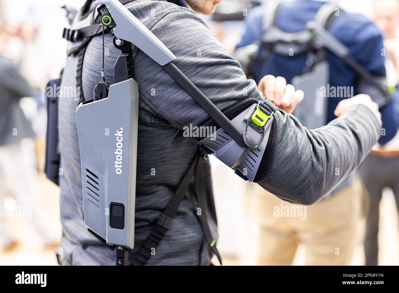 Hanover, Germany. 17th Apr, 2023. An employee wears an exoskeleton for ...