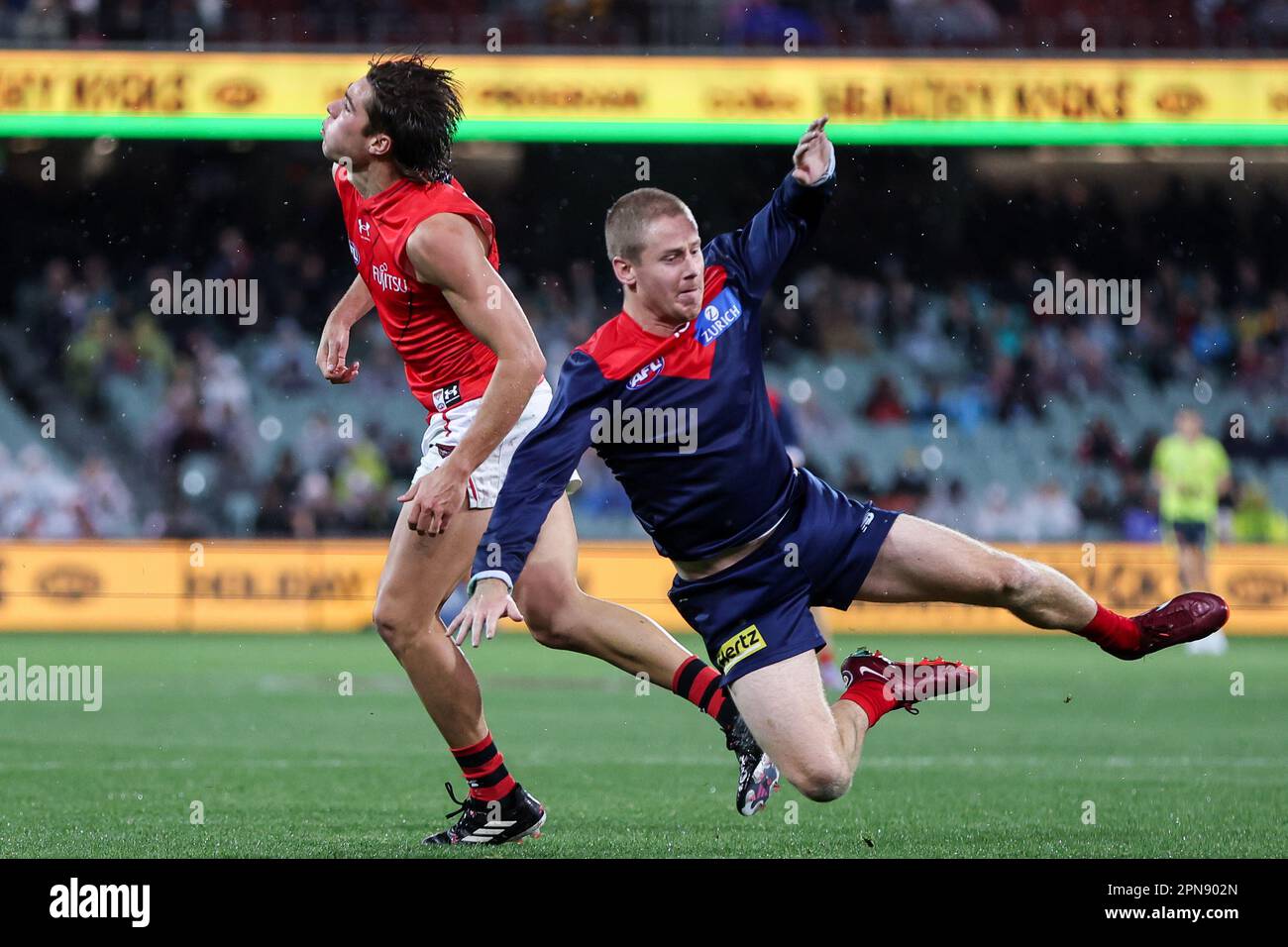 Sam Durham of the Bombers clashes with Lachie Hunter of the Demons ...
