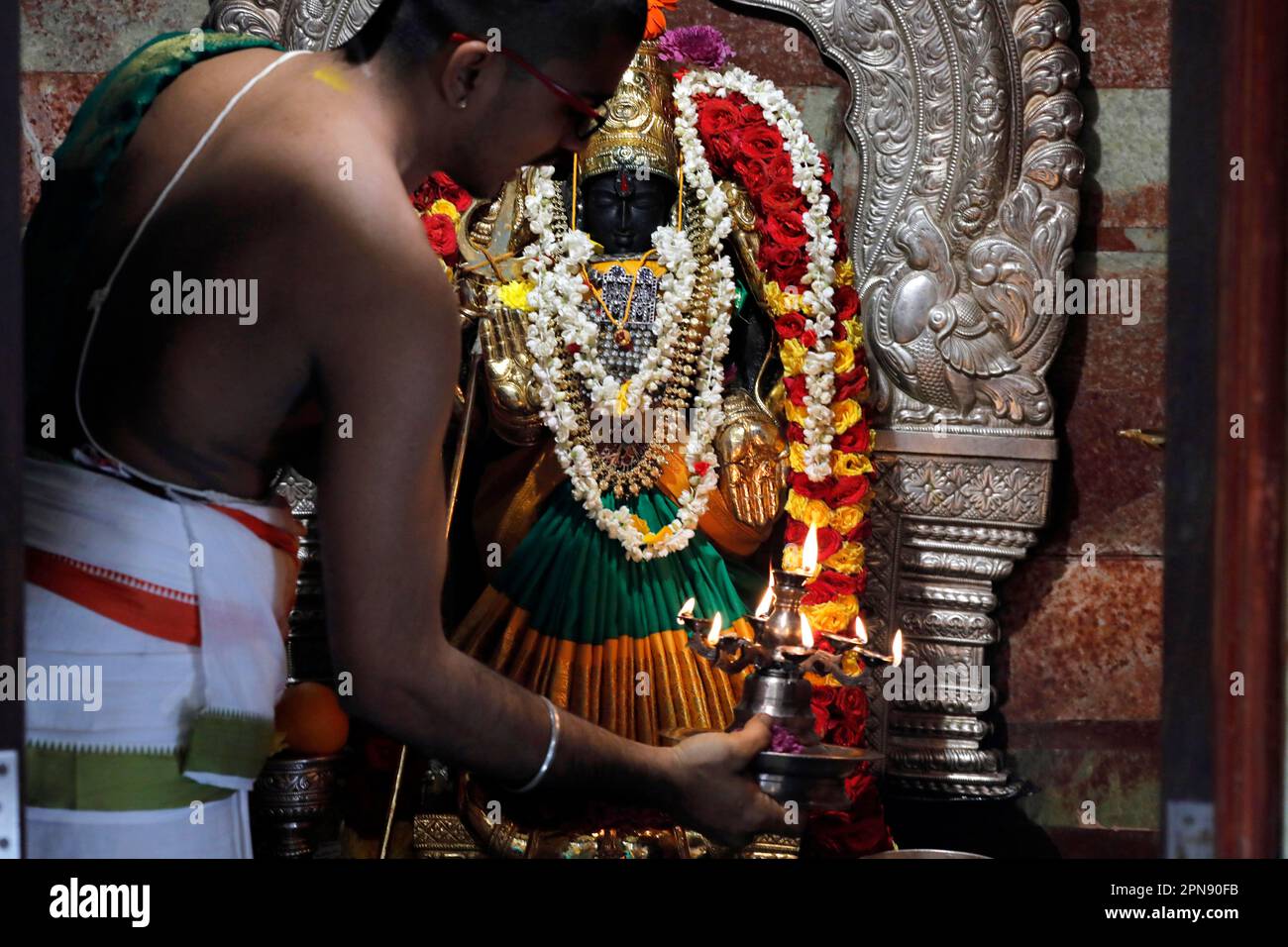 Sri Krishnan hindu temple. Hindu priest ( Brahmin ) performing puja ...