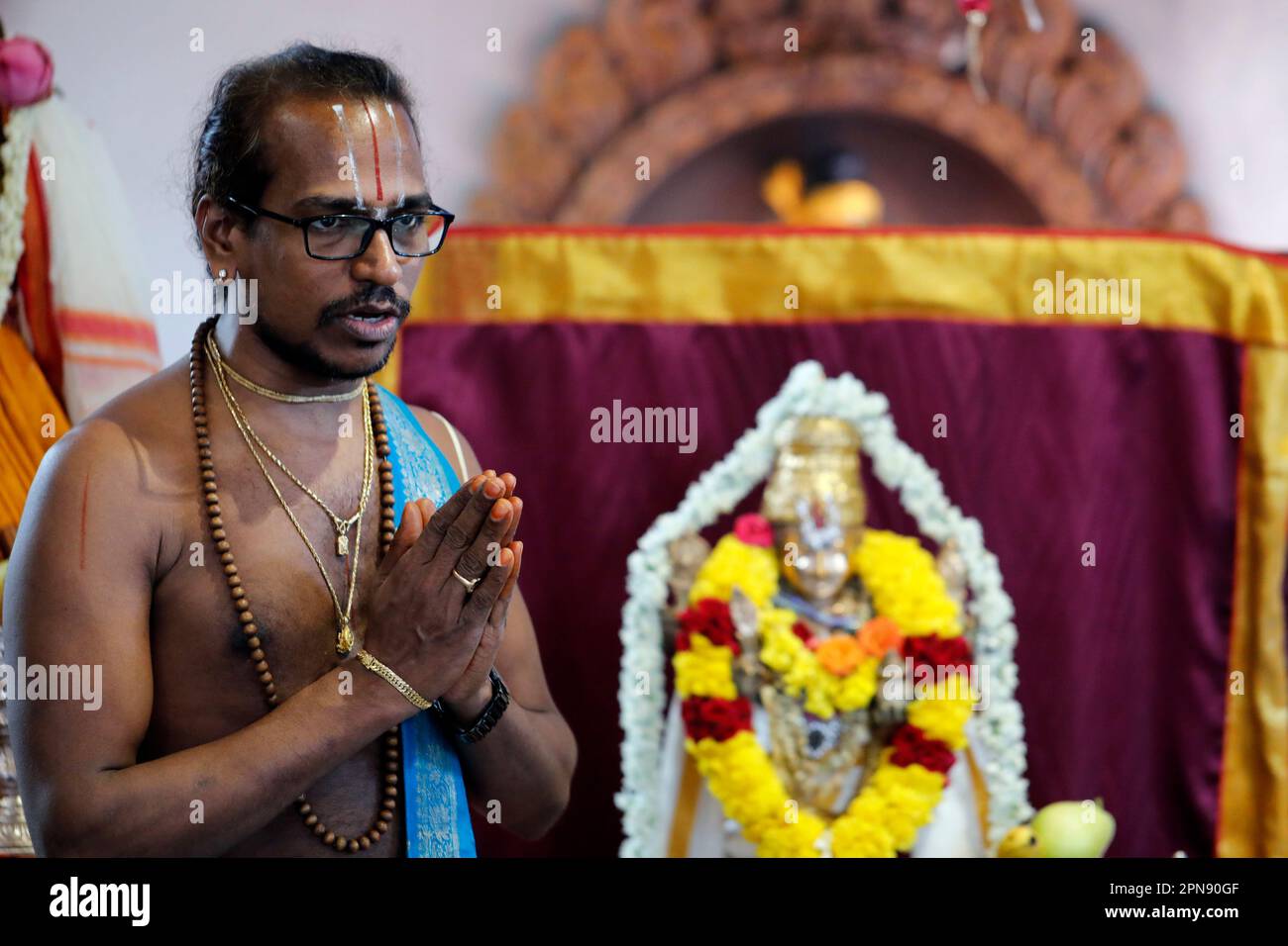Sri Krishnan hindu temple. Hindu priest ( Brahmin ) performing puja ...