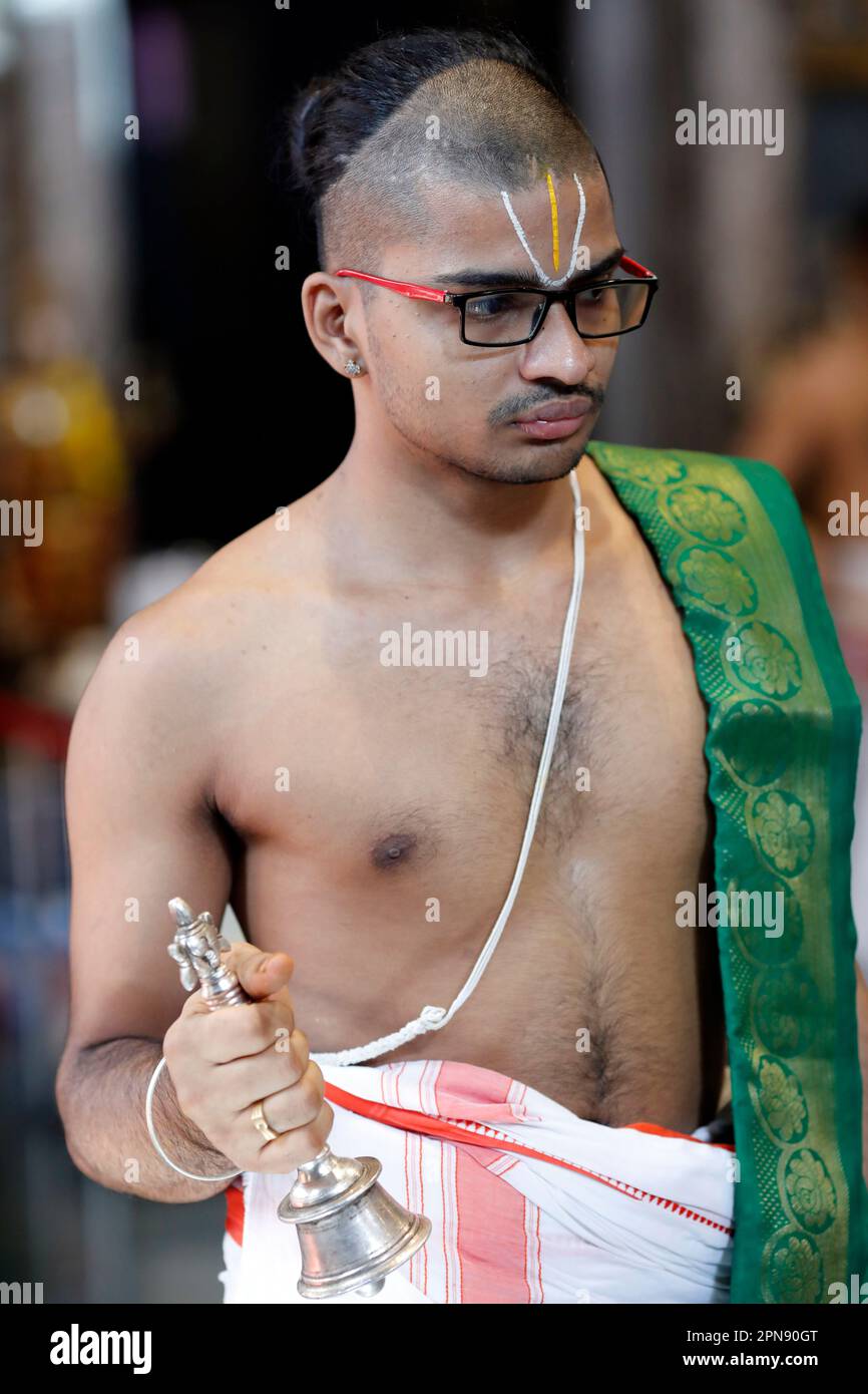 Sri Krishnan hindu temple. Hindu priest ( Brahmin ) performing puja ...