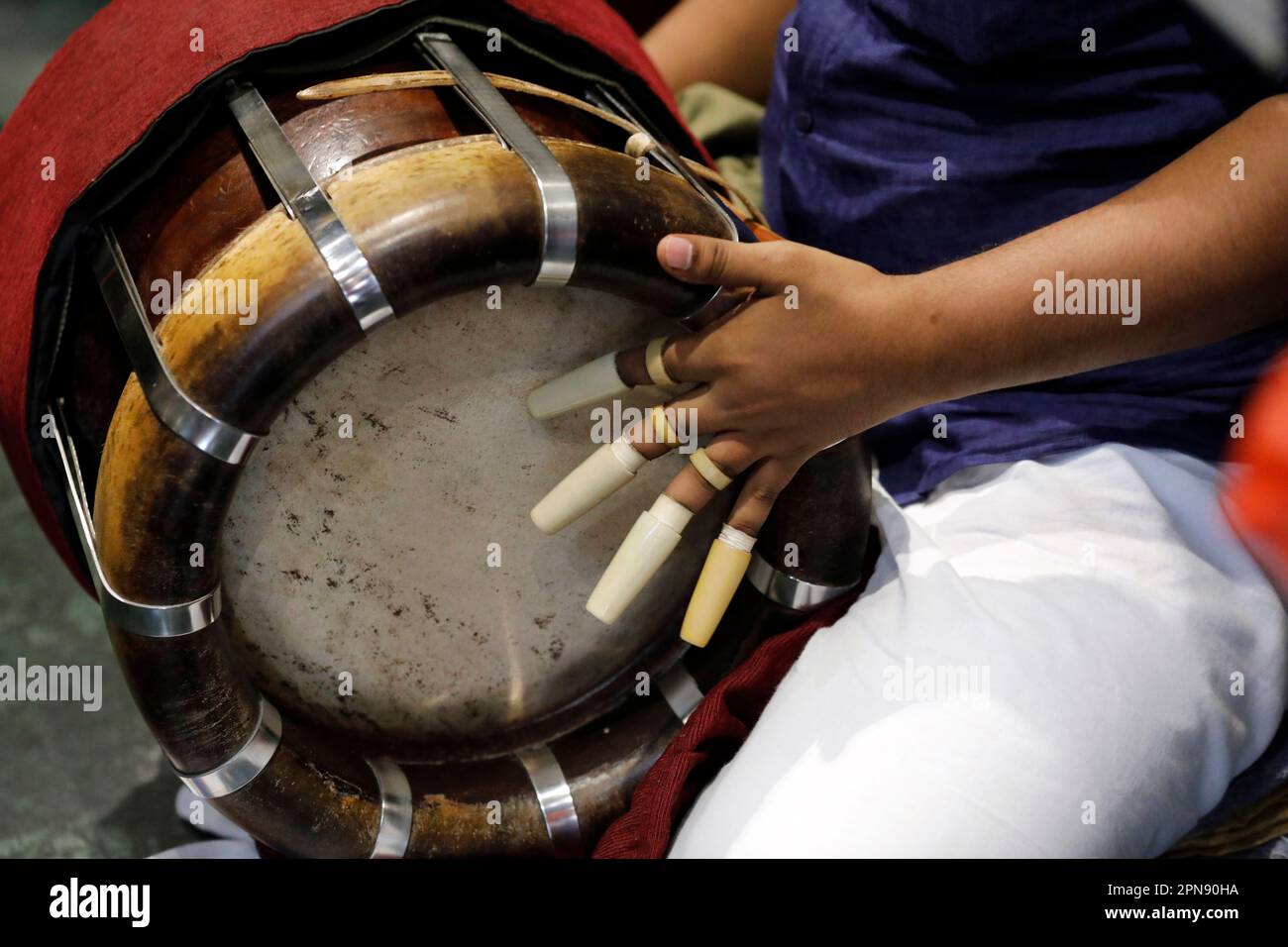 Sri Krishnan hindu temple. Musician playing a Thavil, a traditional ...