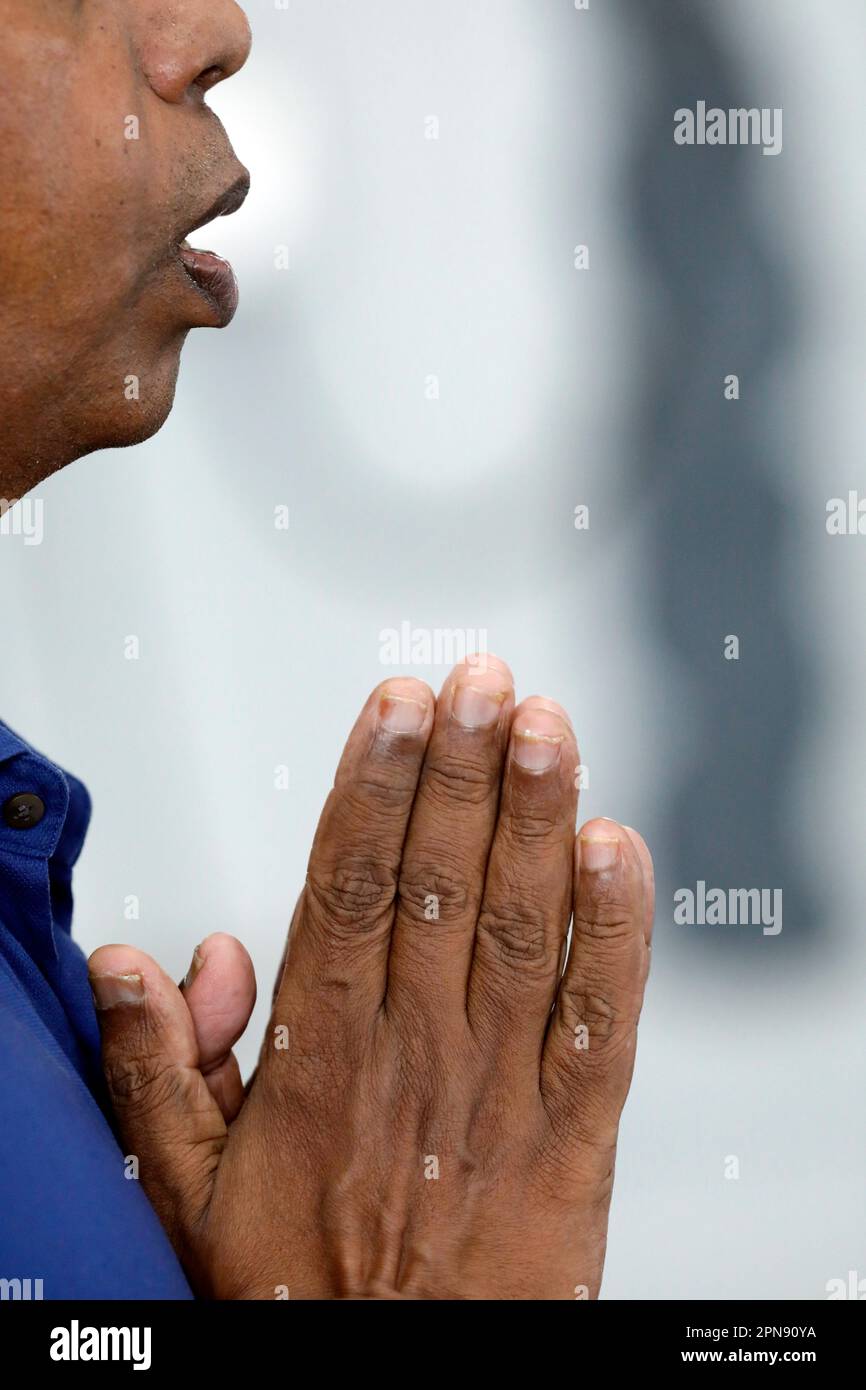 Sri Srinivasa Perumal hindu temple. Man praying in temple. Close up on ...