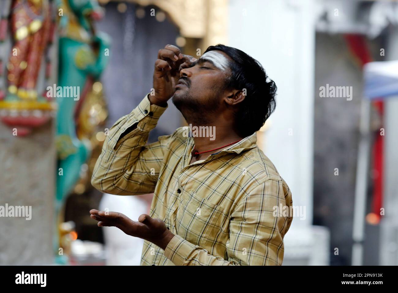 Sri Veeramakaliamman hindu temple. Hindu man apply Tilak on his fore ...
