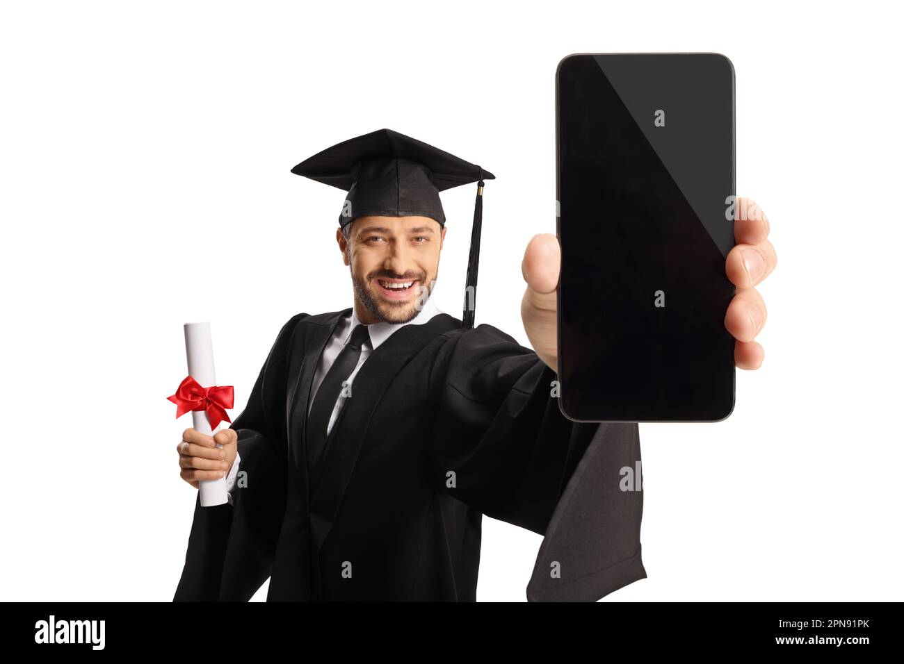 Man in a graduation gown holding a diploma and showing a smartphone ...