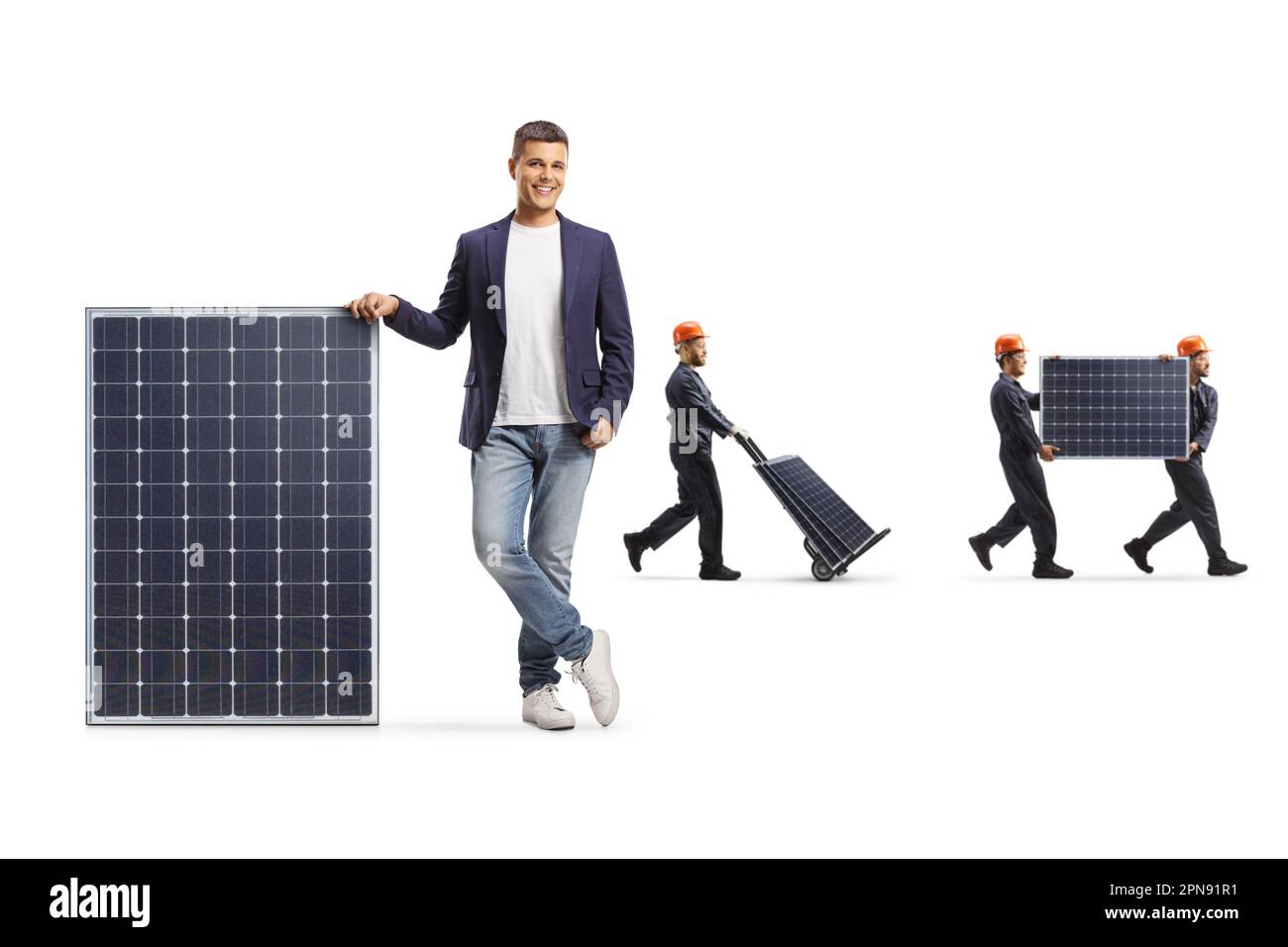 Man leaning on a solar panel and factory workers transporting panels ...