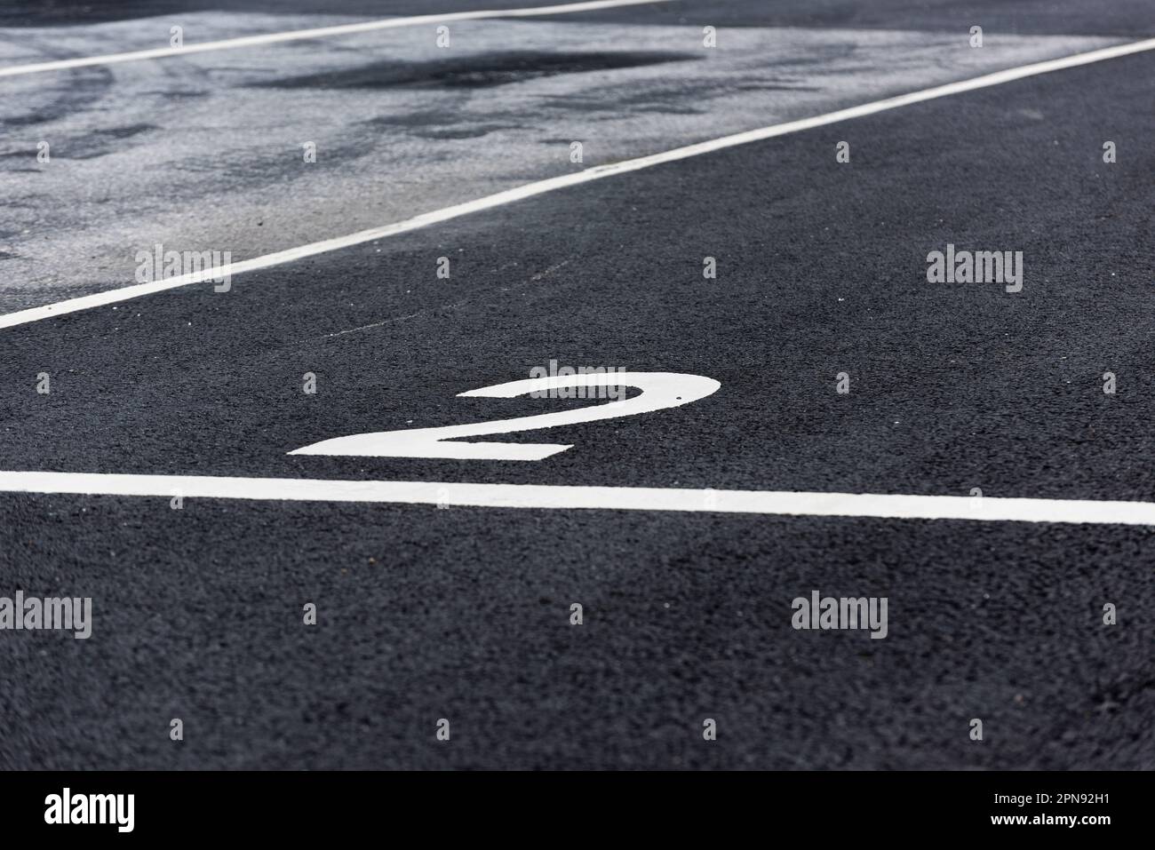 The number two painted on asphalt Stock Photo - Alamy