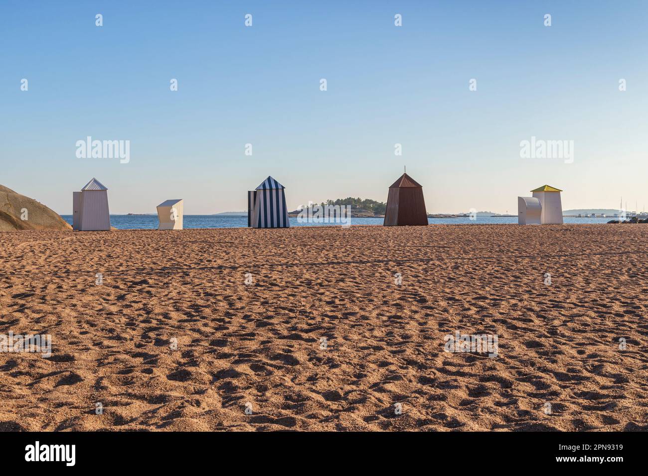 Wooden changing booths or huts at the empty and sandy Casino beach in ...