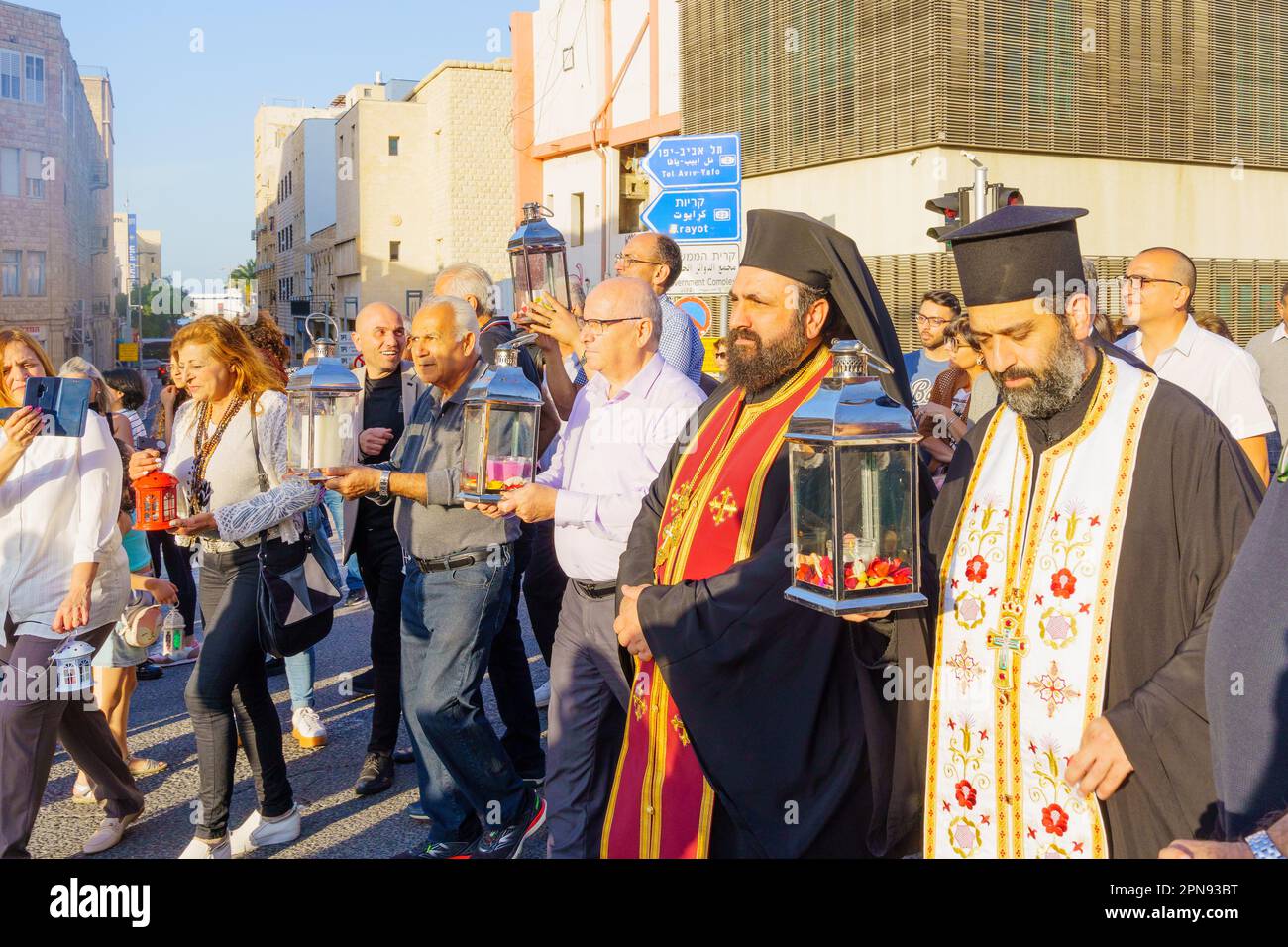 Haifa, Israel - April 15, 2023: Priest and locals carrying the holy ...