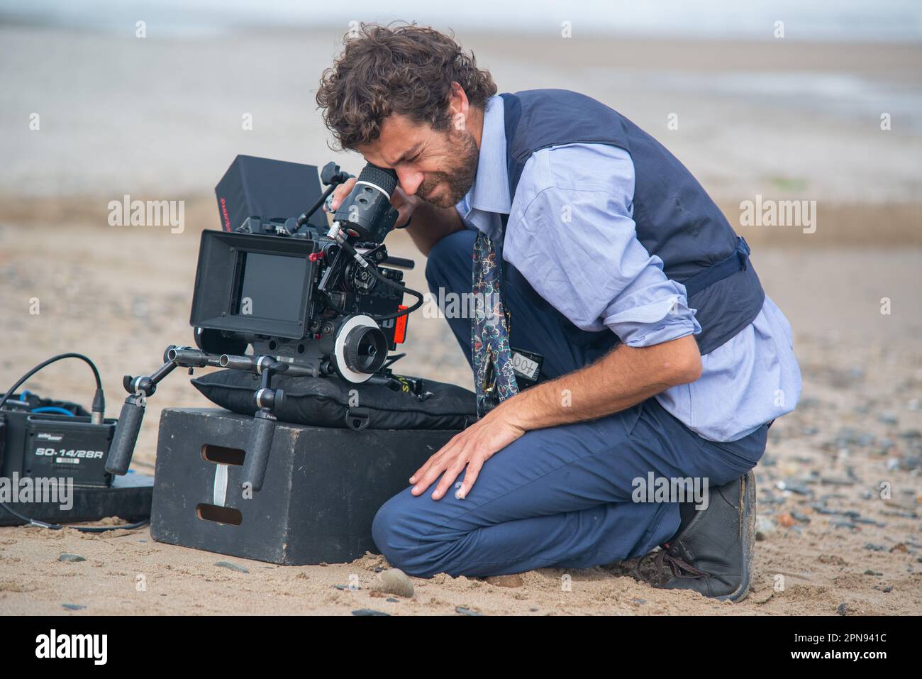 Film crew on coastal location using RED camera Stock Photo - Alamy