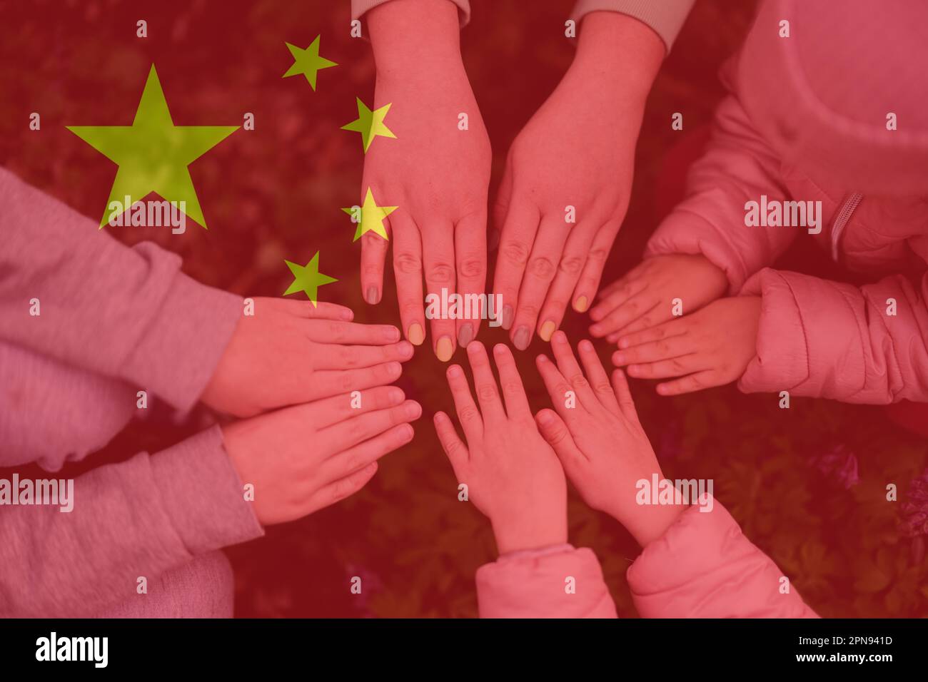 Hands of kids on background of China flag. Chinese patriotism and unity ...