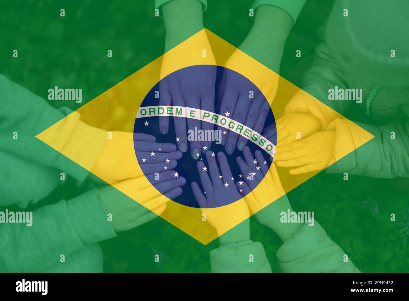 Hands of kids on background of Brazil flag. Brazilian patriotism and ...