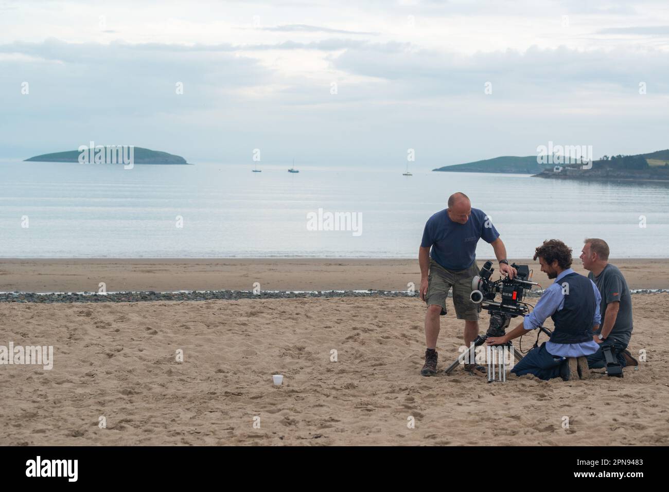 Film crew on coastal location using RED camera Stock Photo - Alamy