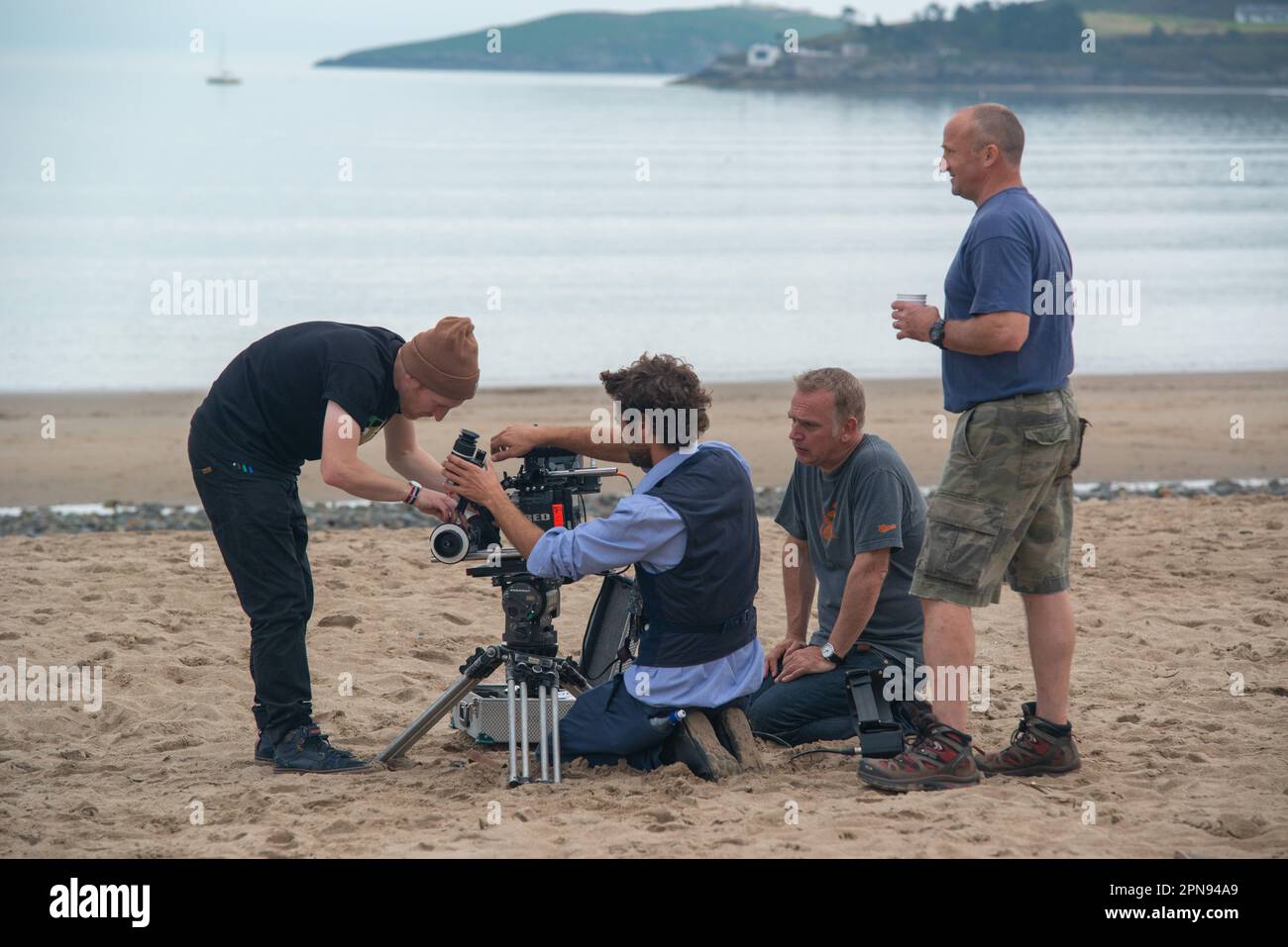 Film crew on coastal location using RED camera Stock Photo - Alamy