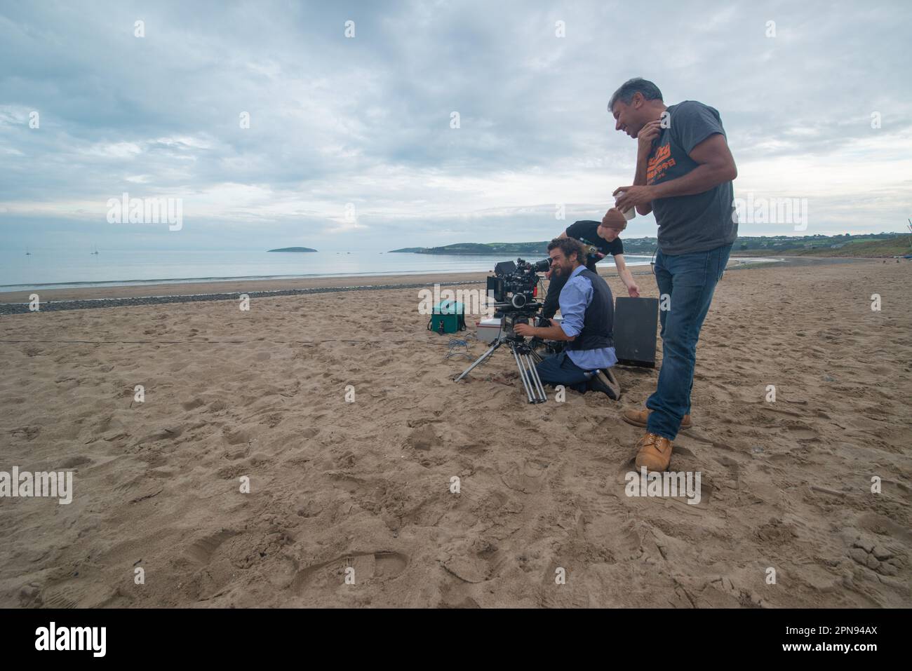 Film crew on coastal location using RED camera Stock Photo - Alamy