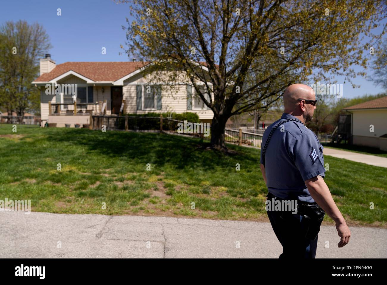 A police officer walks past the house Monday, April 17, 2023, where 16 ...