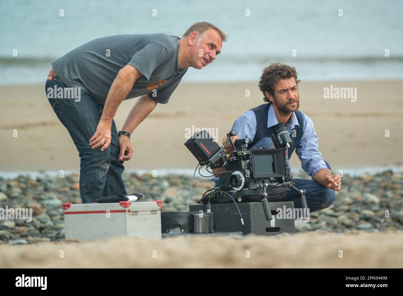 Film crew on coastal location using RED camera Stock Photo - Alamy