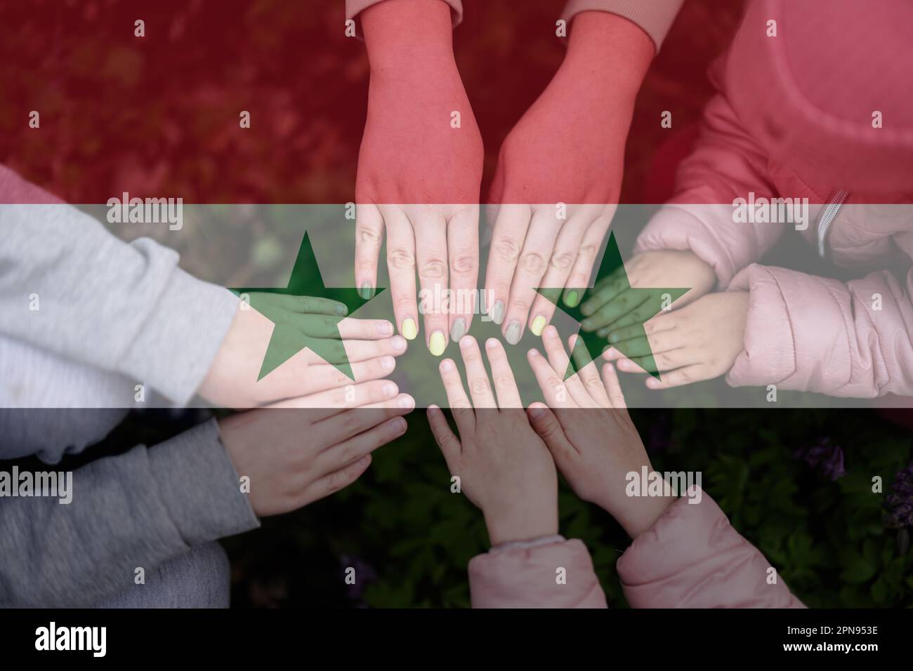Hands of kids on background of Syria flag. Syrian patriotism and unity ...