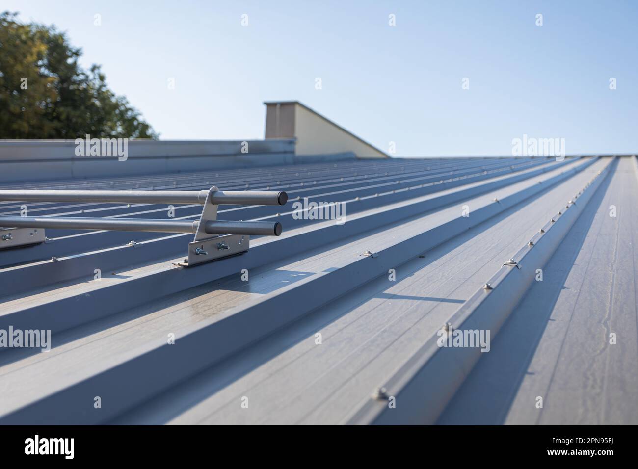 Snow fence noted on trapezoidal sheet metal roof Stock Photo - Alamy