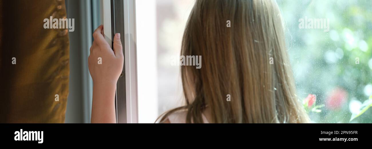 Little girl standing on windowsill at open window Stock Photo - Alamy