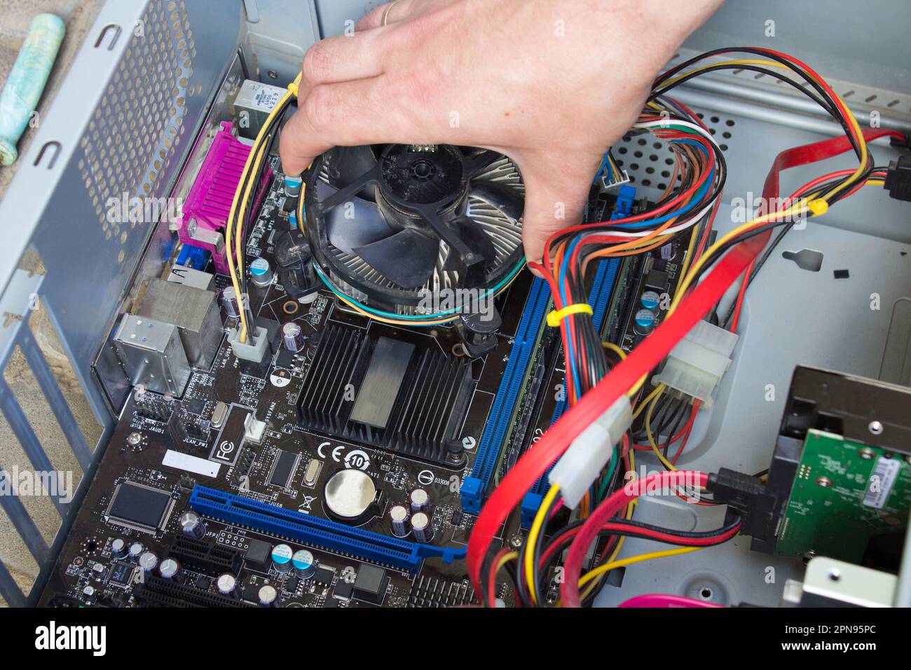 The person repairs the motherboard of the computer, disassembling the ...