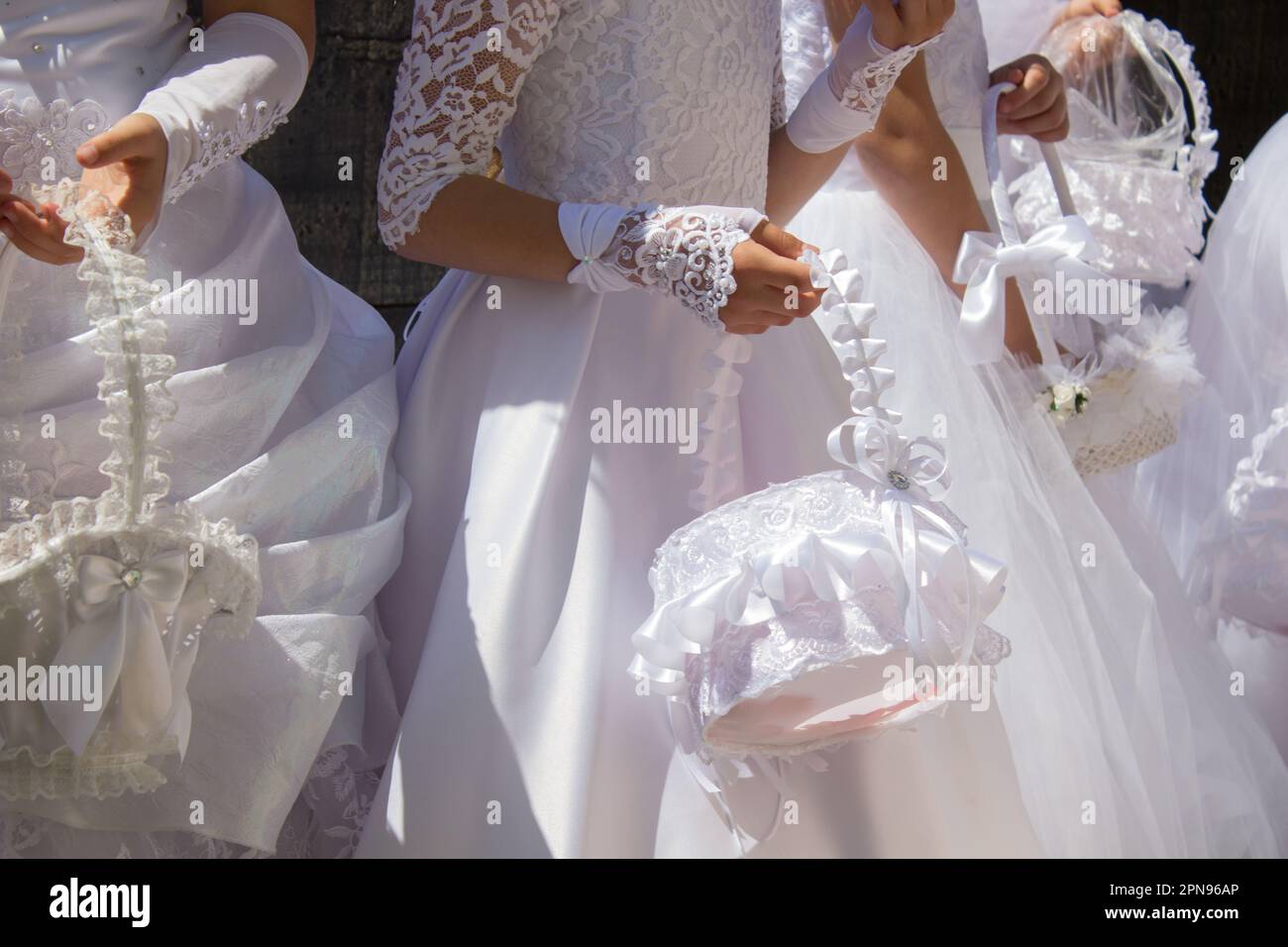 Child dressed up for her first communion with white dress and veil ...