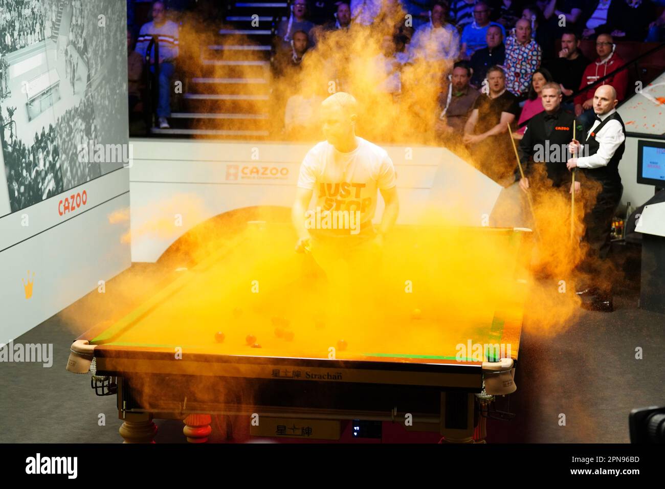 A Just Stop Oil protester jumps on the table and throws orange powder ...