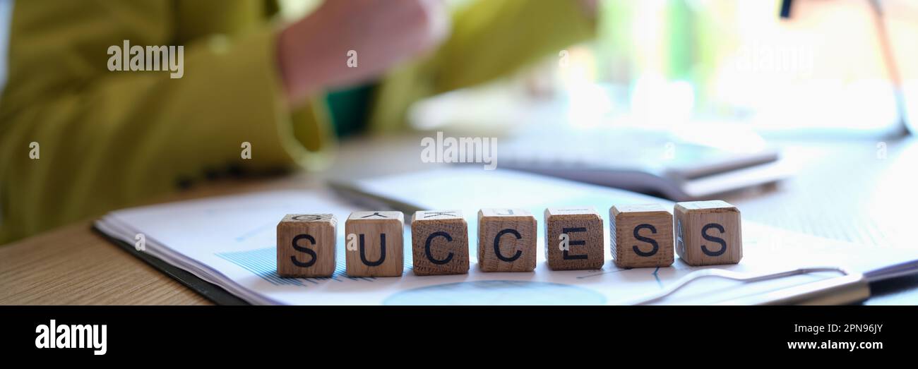 Success word made with wooden cubes in row Stock Photo - Alamy