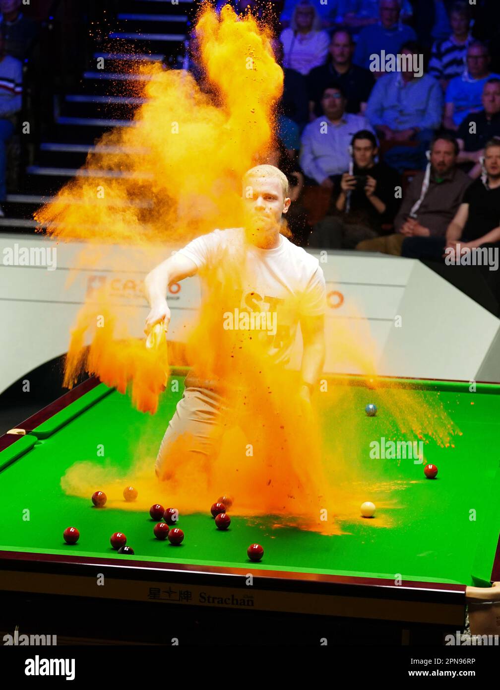 A JUST STOP OIL protester jumps on the table during the match between ...