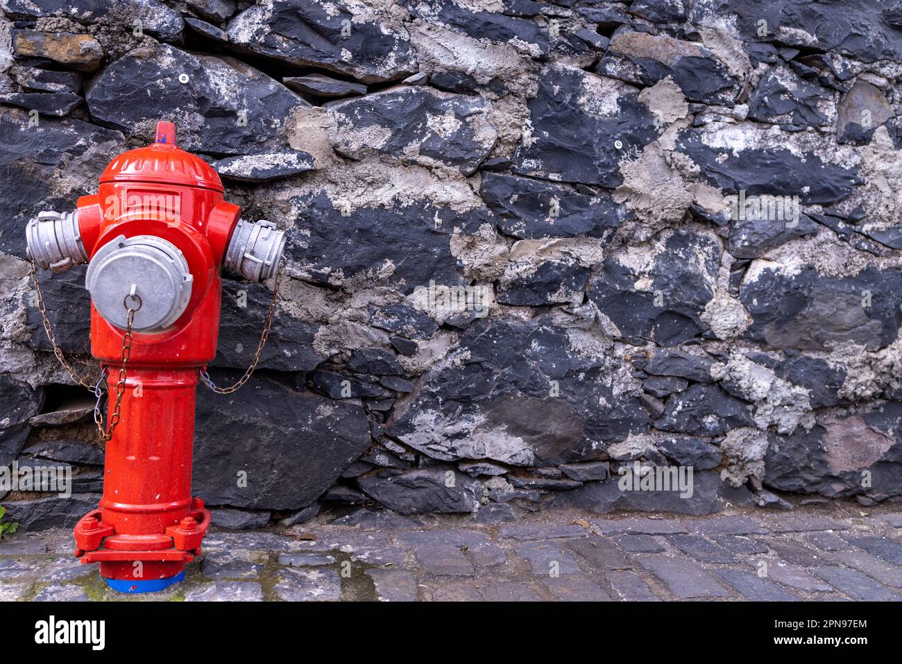 A red fire hydrant pipes used by fire fights to attach to their fire ...