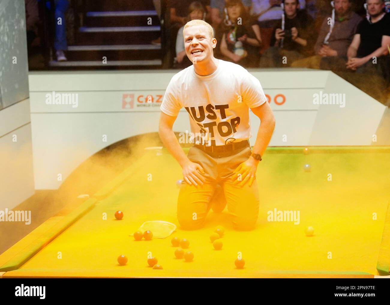 A Just Stop Oil protester jumps on the table and throws orange powder ...