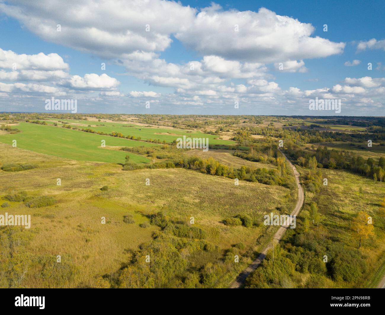 An aerial view of the cloudy blue sky over the idyllic rural landscape ...