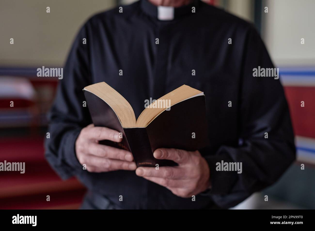 Church father reading bible hi-res stock photography and images - Alamy