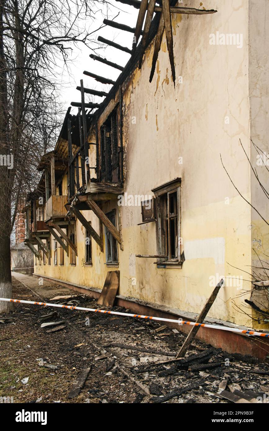 Facade of an old two-story house after a fire. Burnt residential ...