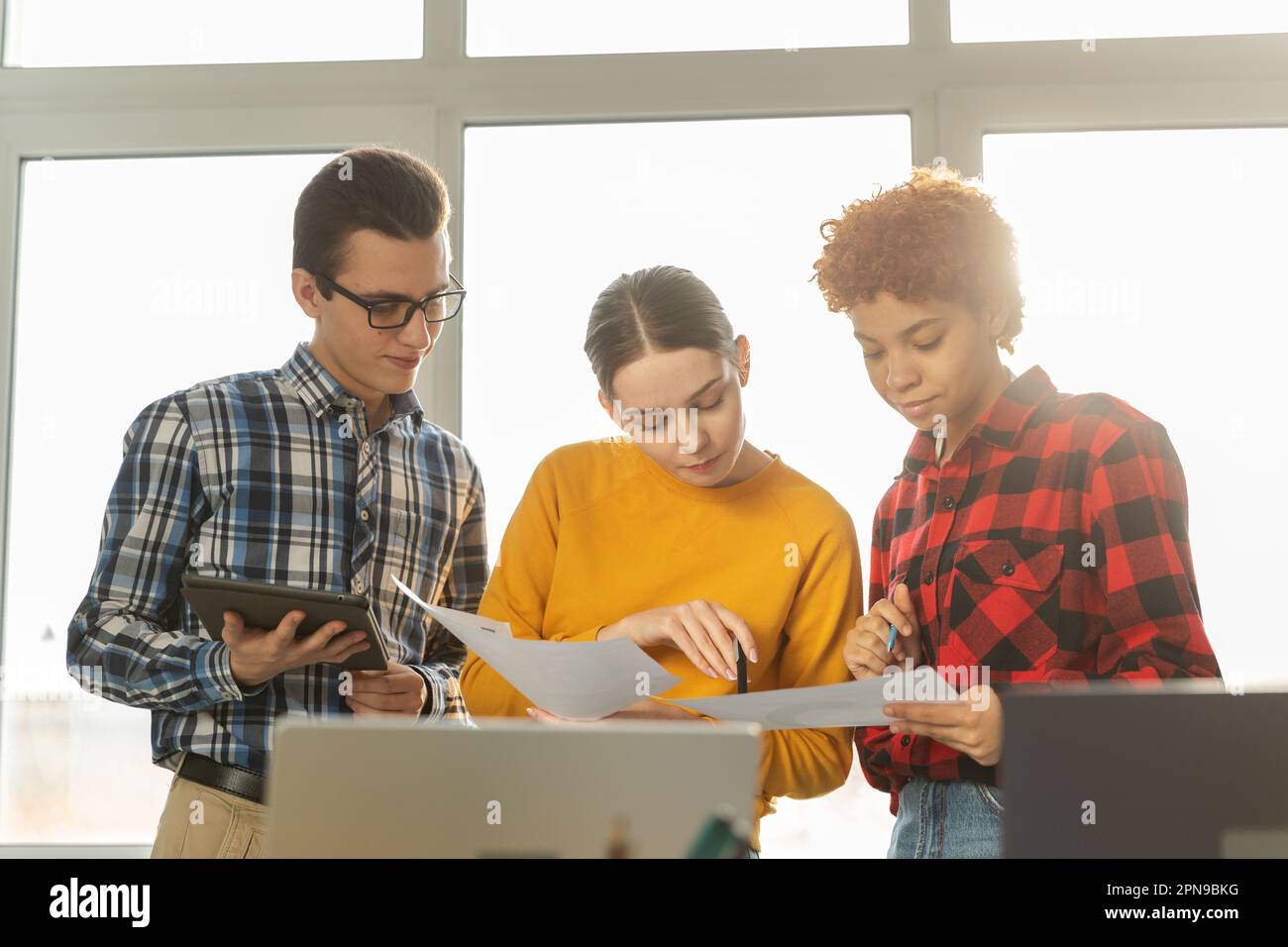 Teamwork brainstorm young professional team concept. Happy multiracial coworkers cooperating ...