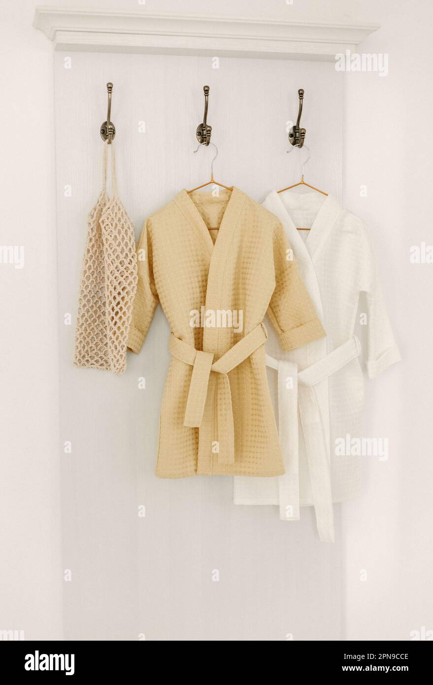 Linen bathrobes hang on a hanger in the bathroom Stock Photo - Alamy