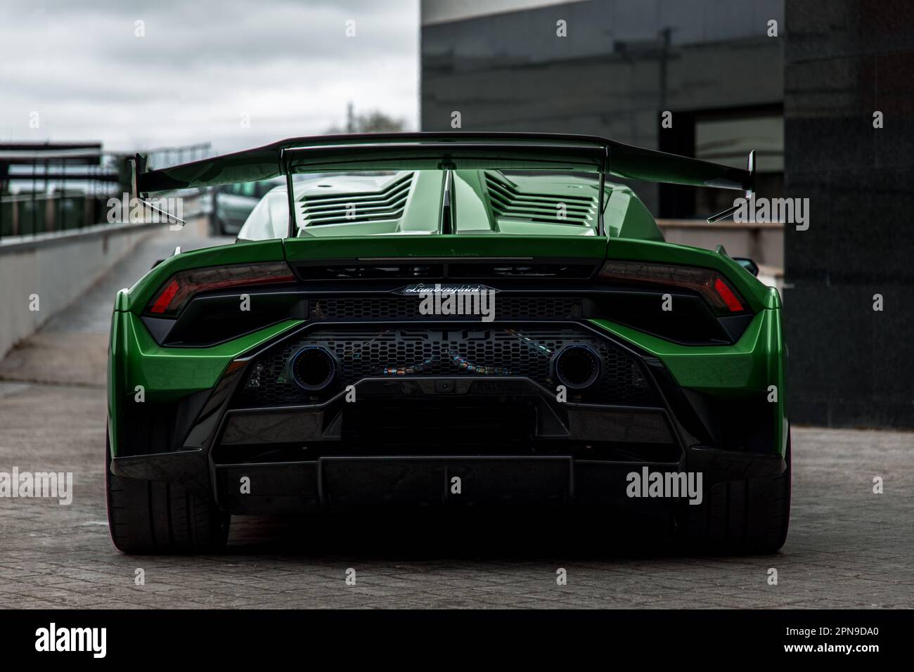 A rear view of a luxurious green Lamborghini Huracan Sto parked ...