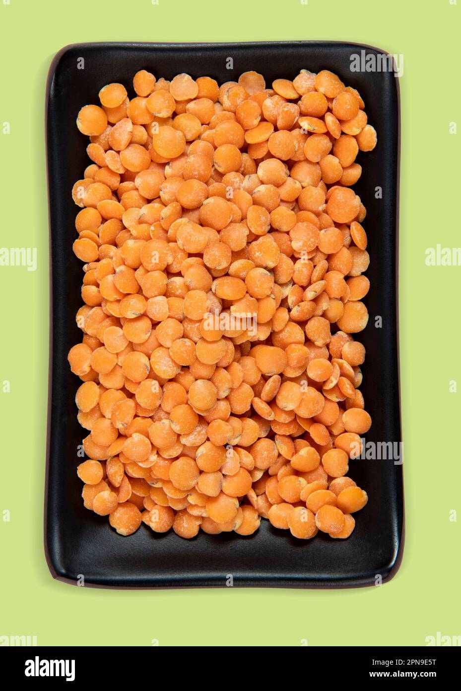 Red lentil in ceramic bowl isolated on pink background. Top view. Flat ...