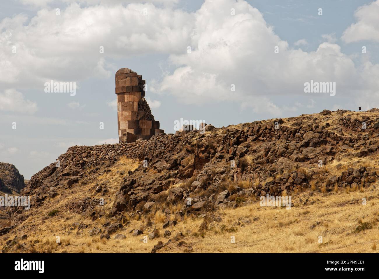 The ruins of a tower-like tomb (called a chullpa) in Sillustani, Puno ...