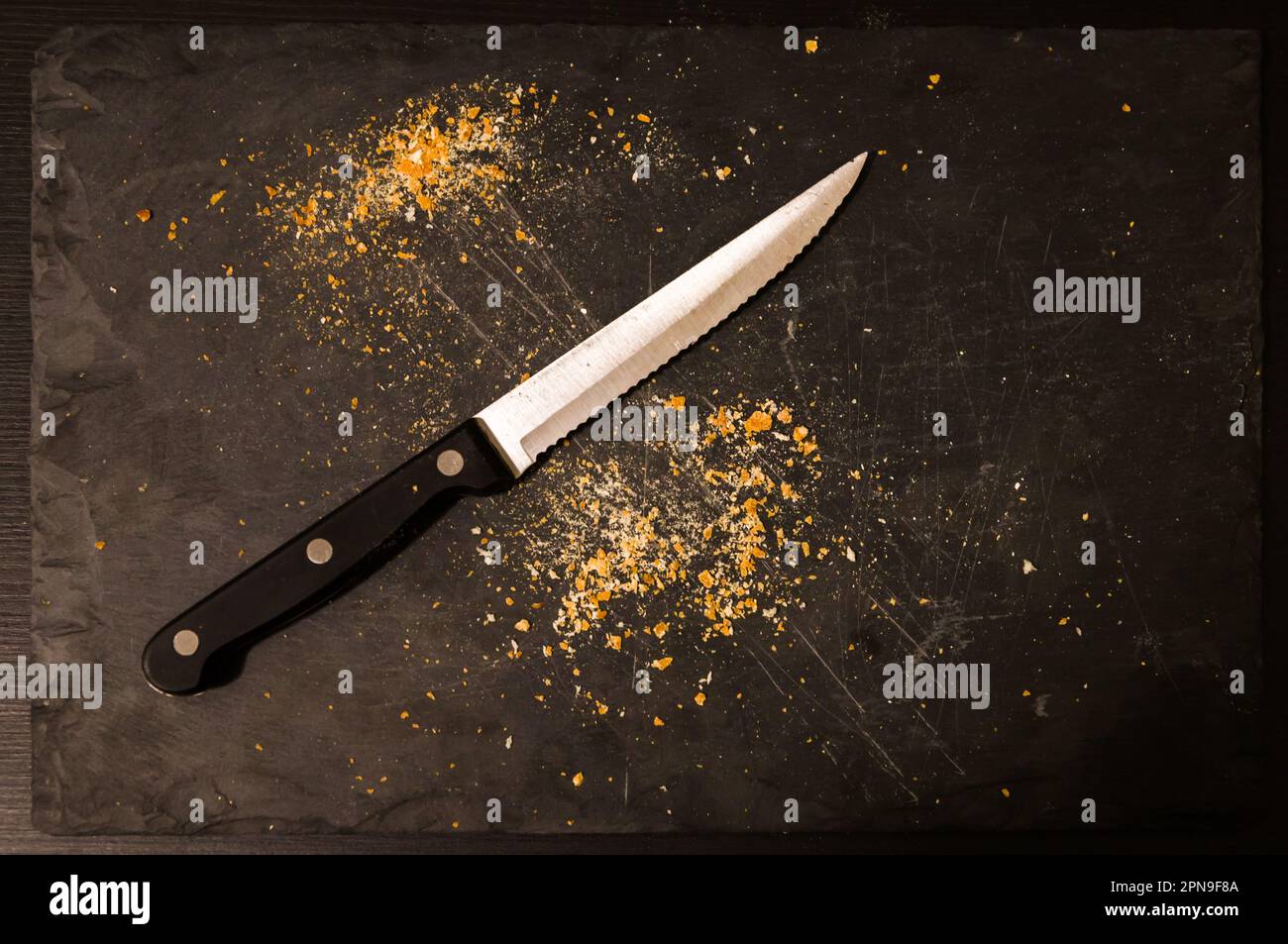 Empty board with bread crumbs and knife. Food and cutlery. The concept ...