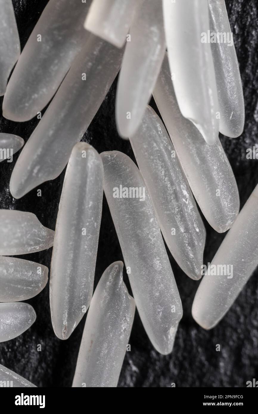 White rice on a black graphite stone slab, healthy food Stock Photo - Alamy