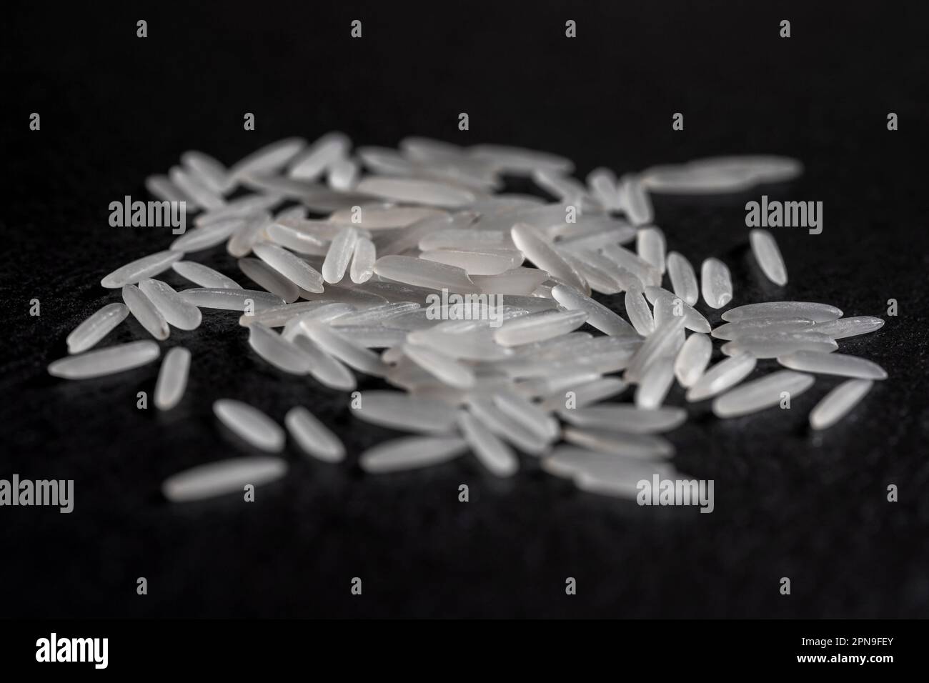 White rice on a black graphite stone slab, healthy food Stock Photo - Alamy