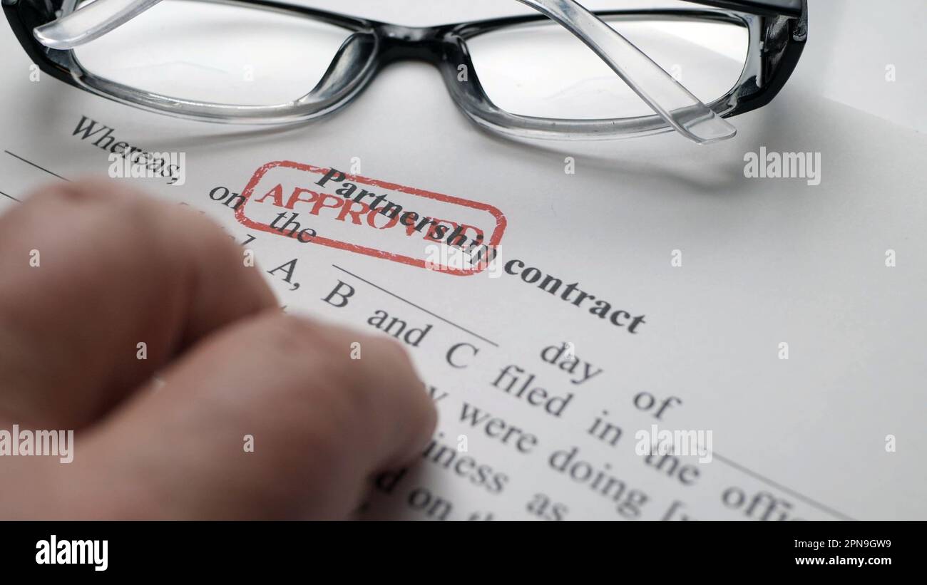 Finger tapping on partnership contract Stock Photo - Alamy
